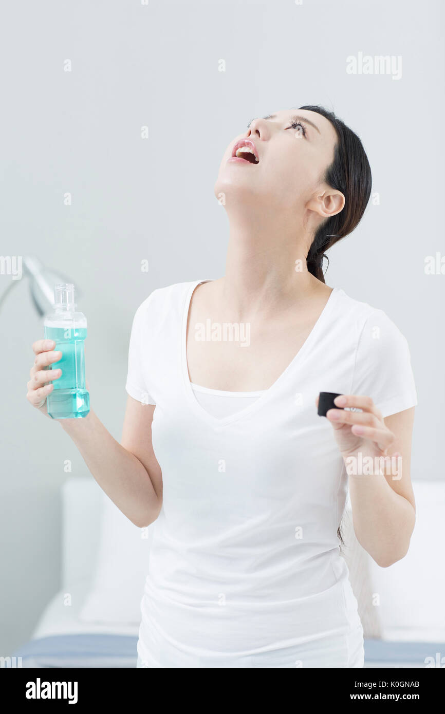 Portrait of woman with mouthwash Stock Photo - Alamy