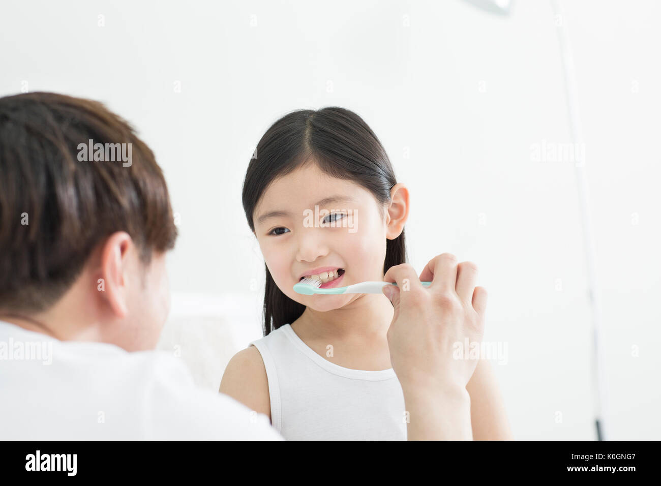 Portrait of father and smiling daughter brushing teeth Stock Photo - Alamy
