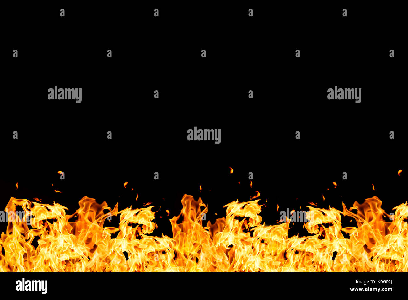 Wall of fire on black background Stock Photo - Alamy