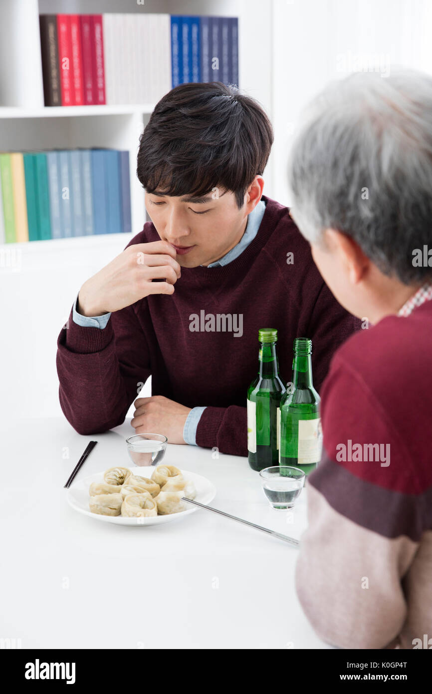 Portrait of young man and his senior father drinking Stock Photo - Alamy