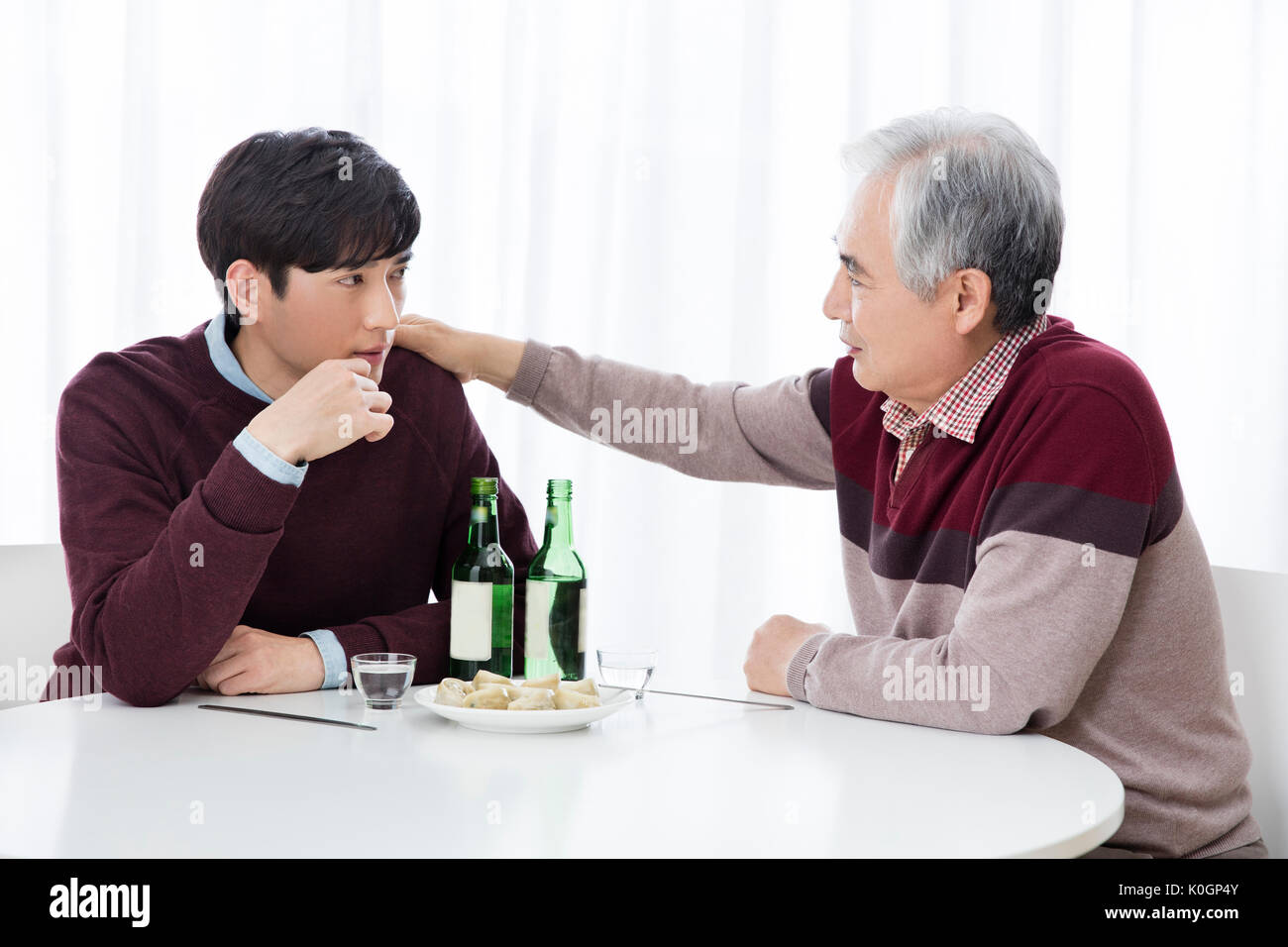 Portrait of young man and his senior father drinking Stock Photo - Alamy