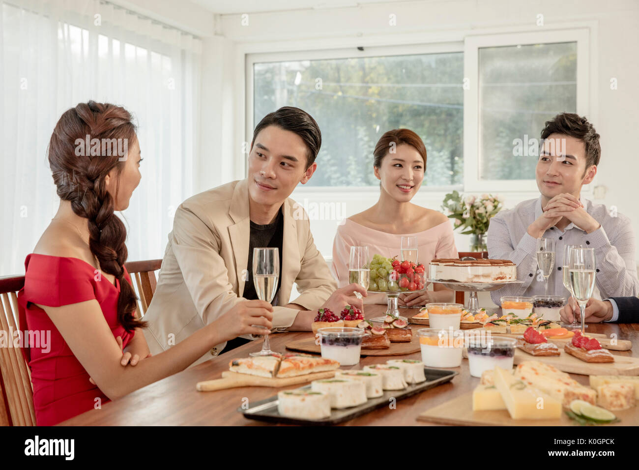 Portrait of young smiling friends having talks at party Stock Photo - Alamy