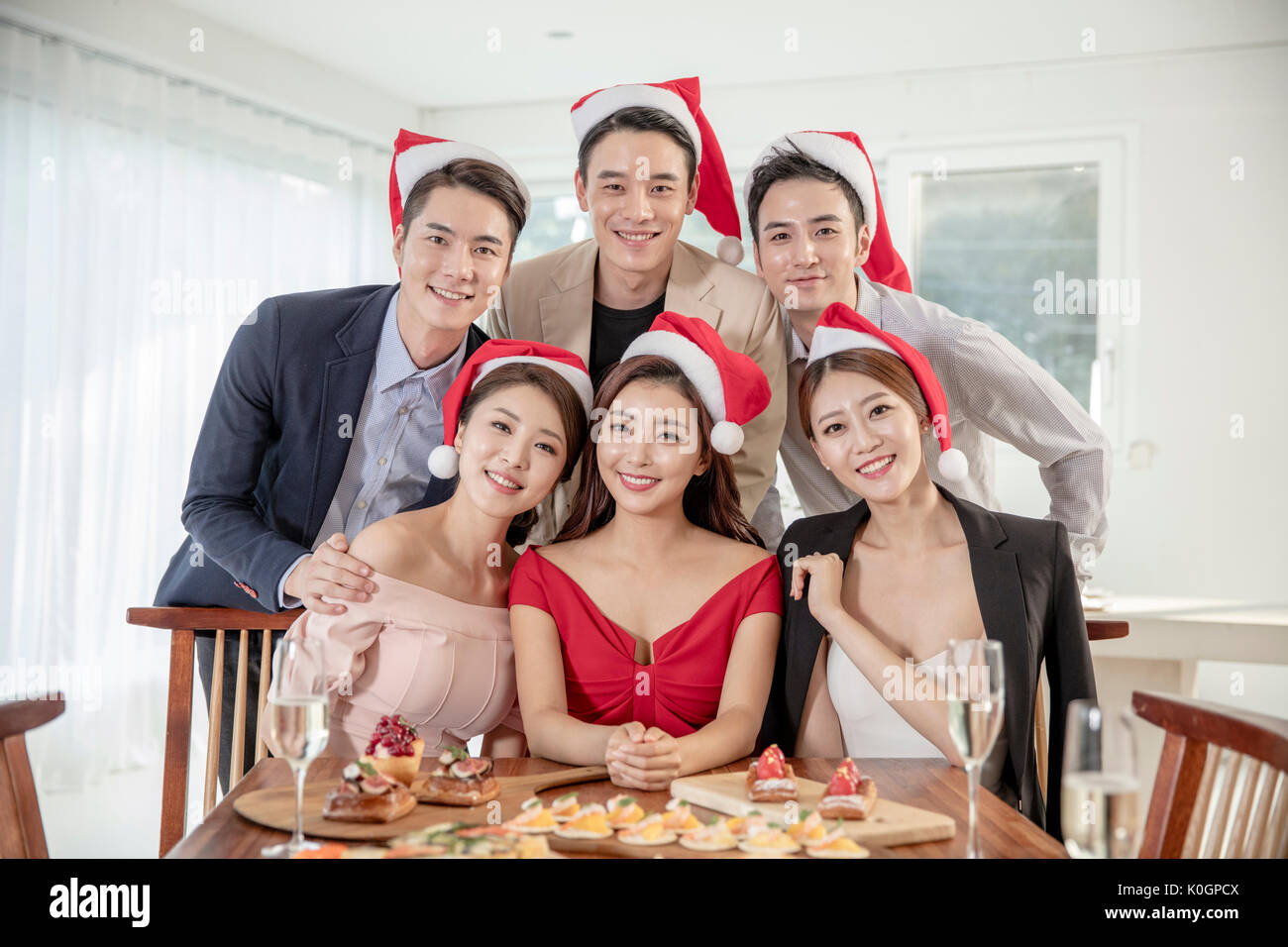 Smiling people posing at Christmas party Stock Photo - Alamy