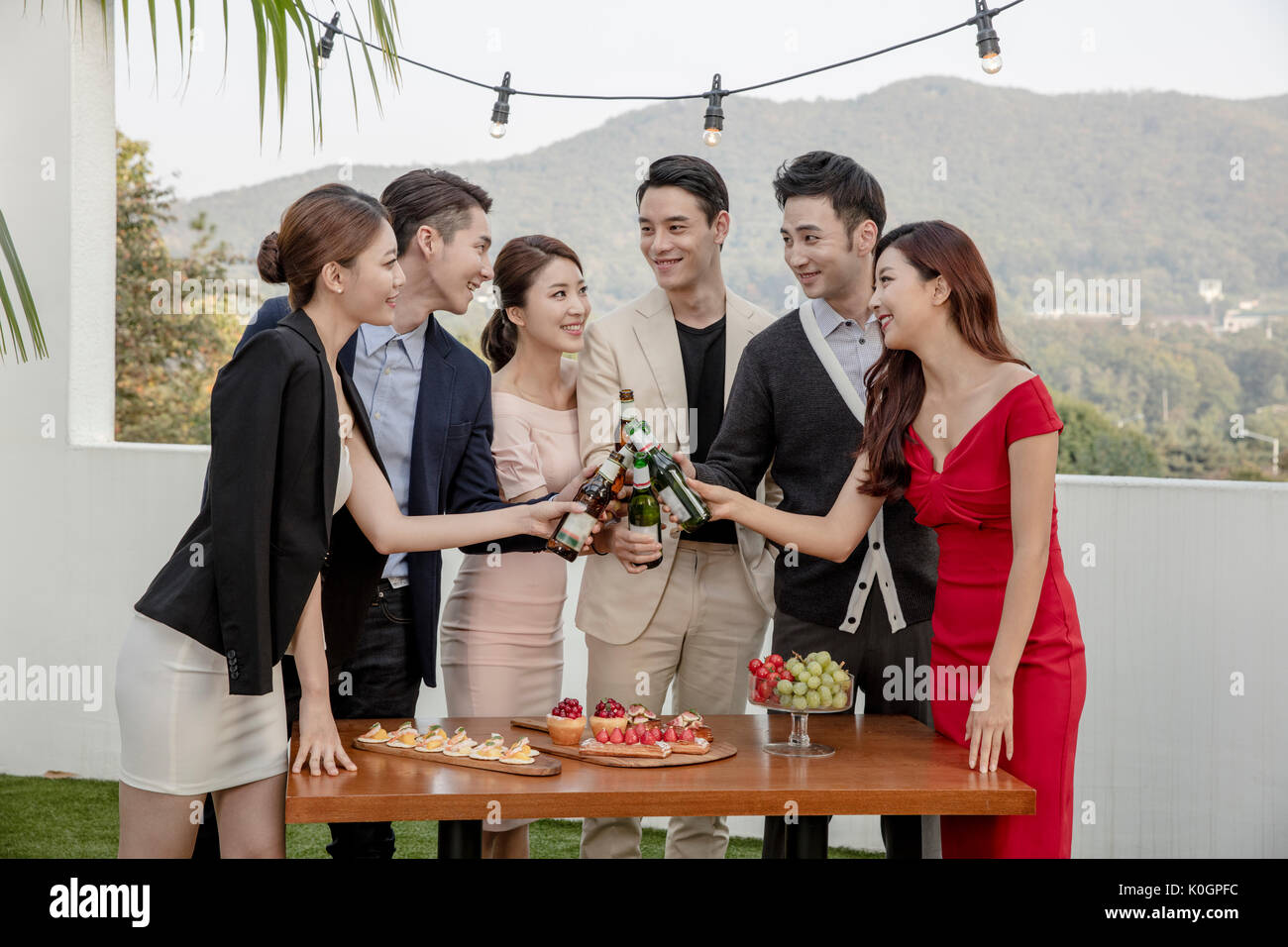 Young smiling friends having a party on rooftop Stock Photo - Alamy