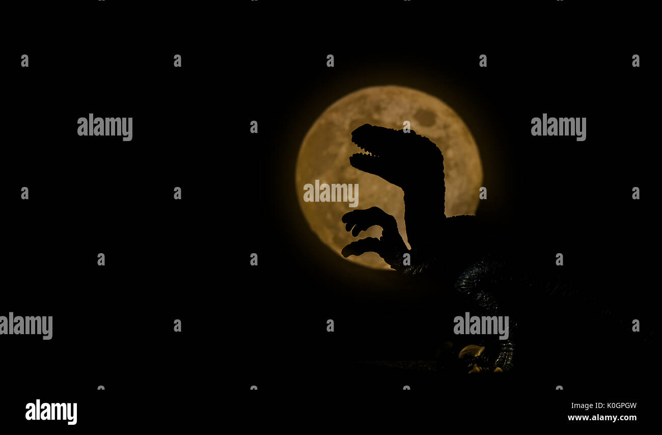 dinosaur with full moon, silhouette on dark night Stock Photo - Alamy