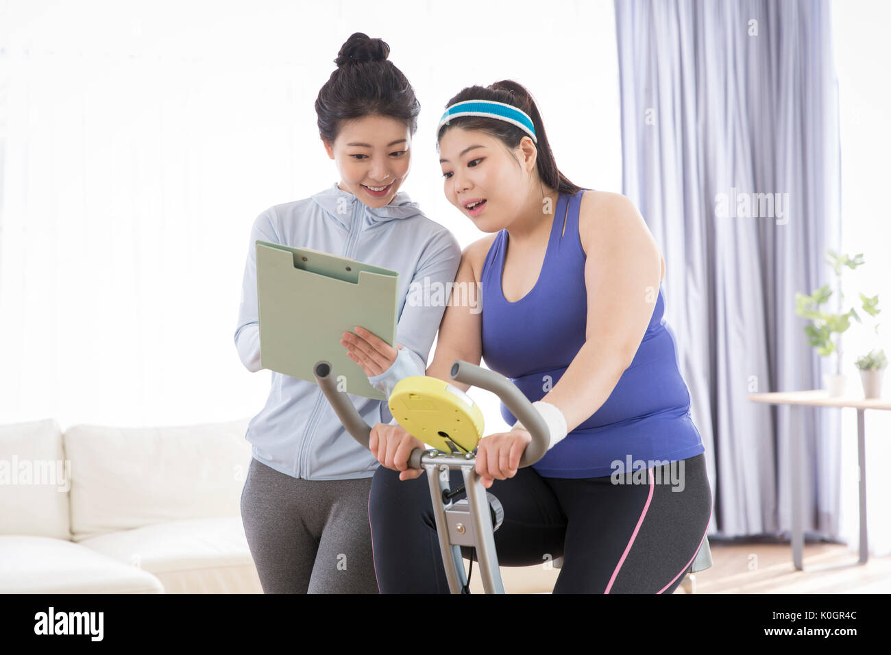 Trainer showing female trainee workout hi-res stock photography and ...