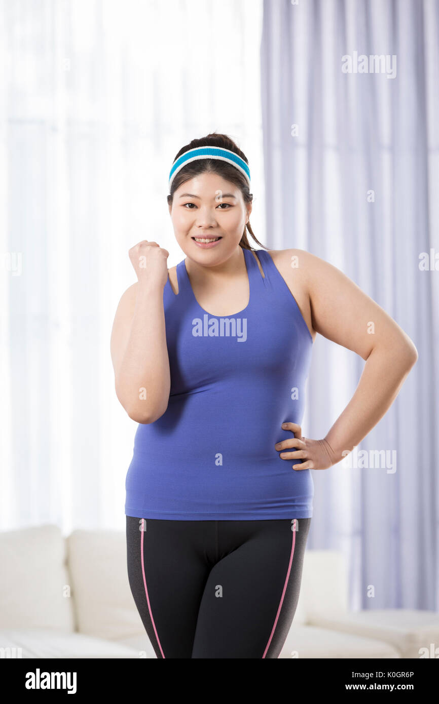 Young smiling confident fat woman cheering Stock Photo - Alamy