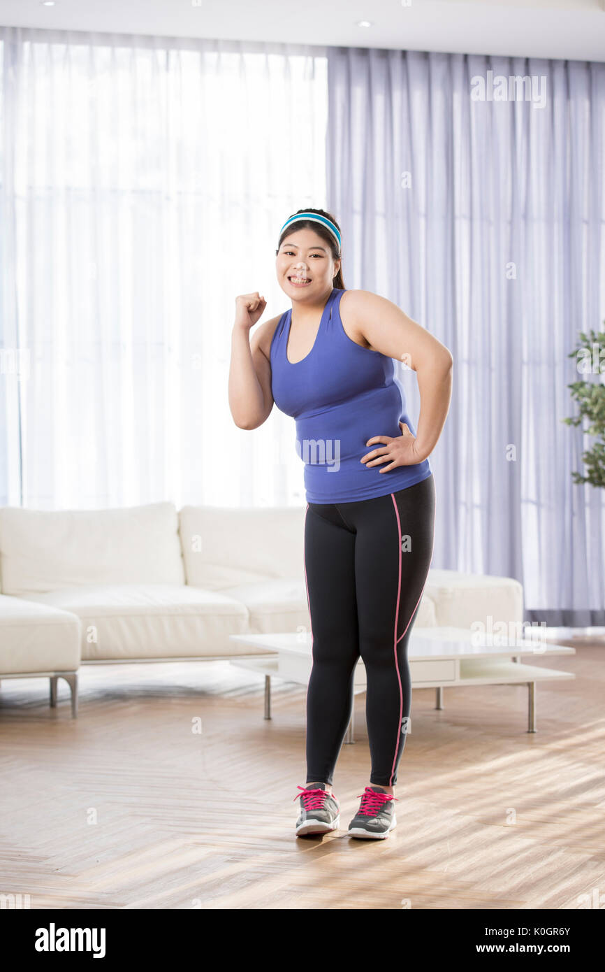 Young smiling confident fat woman cheering Stock Photo - Alamy