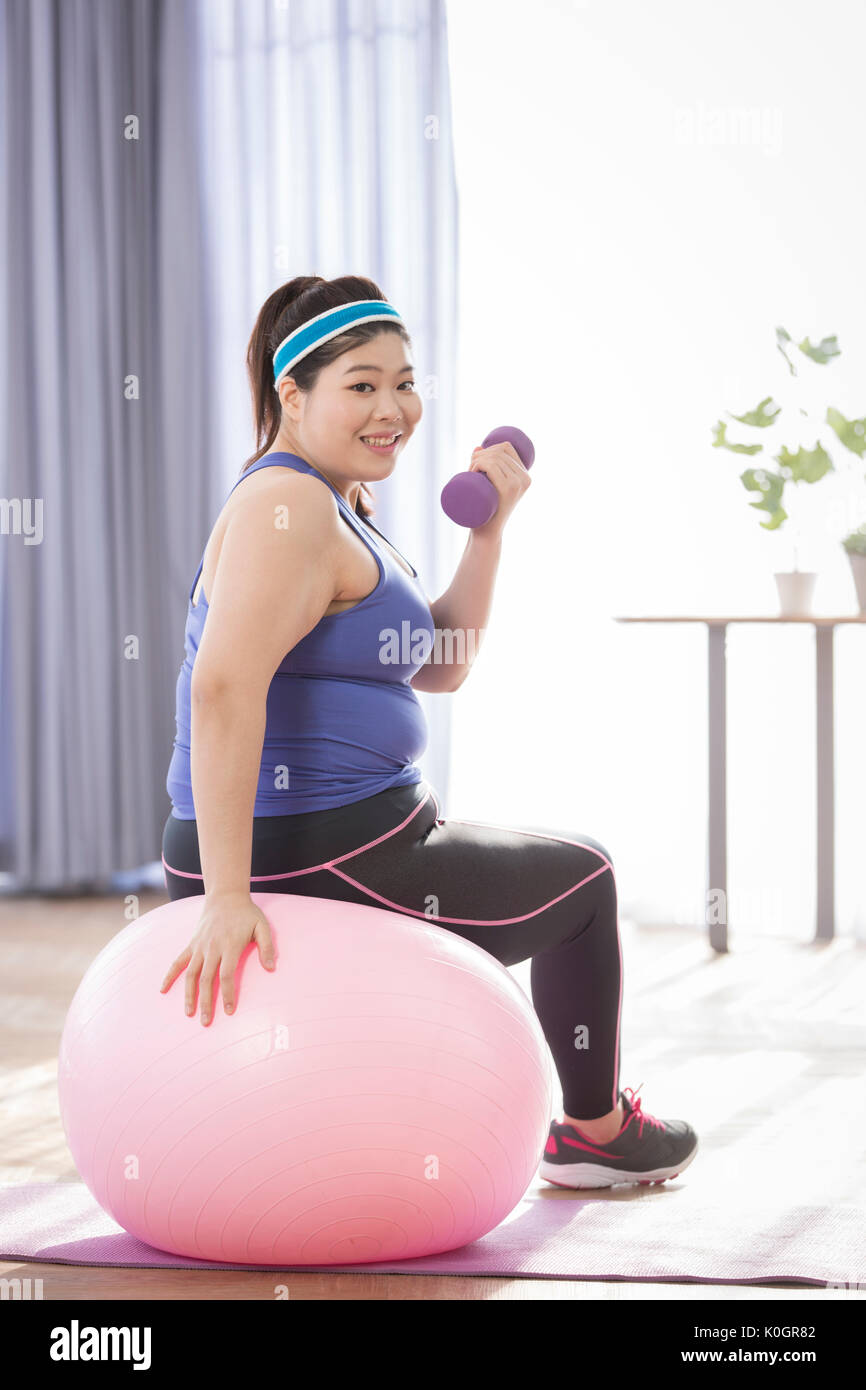 Overweight woman sitting gym ball hi-res stock photography and images ...
