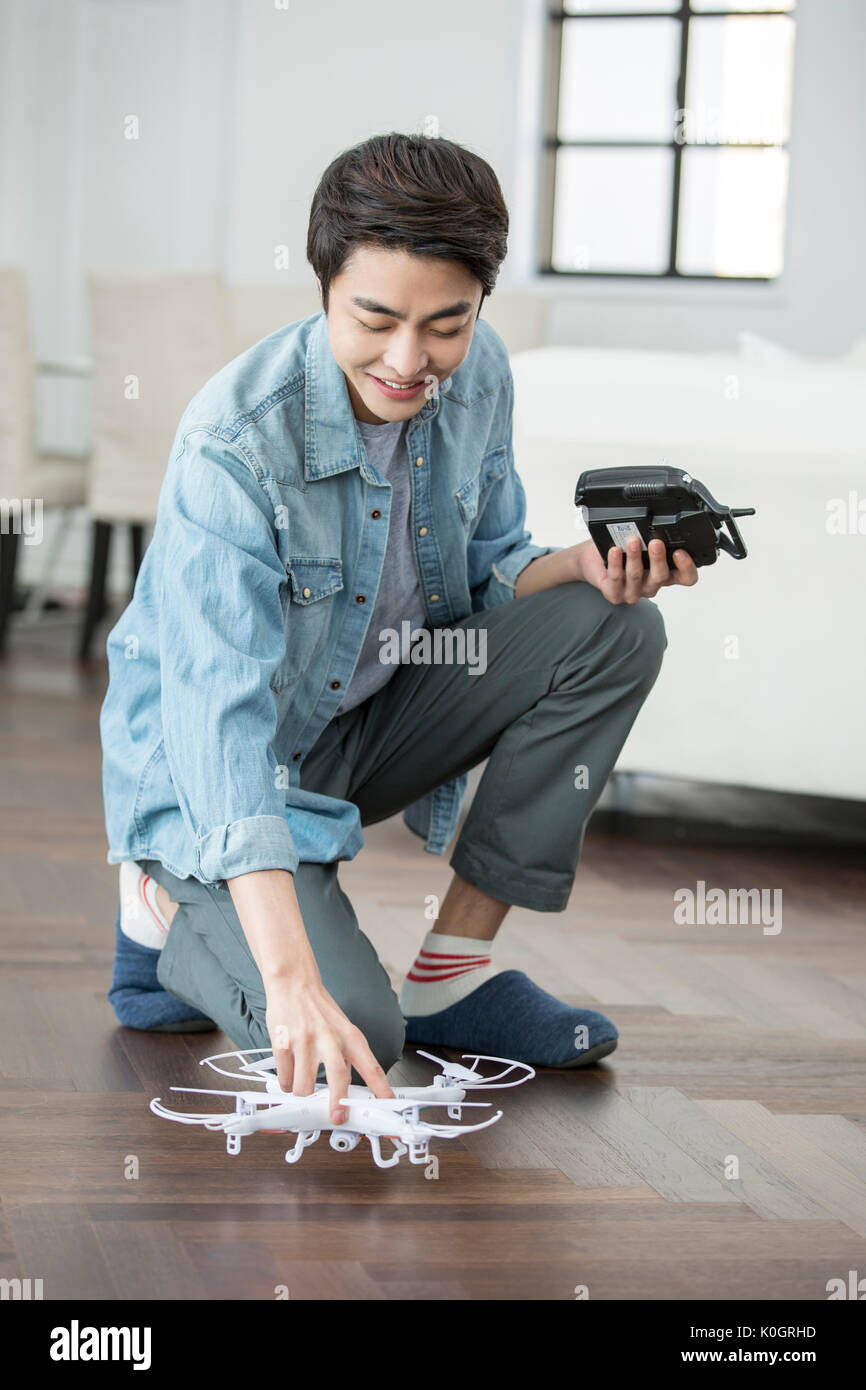 Smiling male kidult playing a drone Stock Photo - Alamy