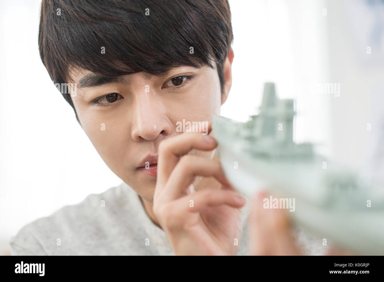 Portrait of male kidult making a toy Stock Photo - Alamy