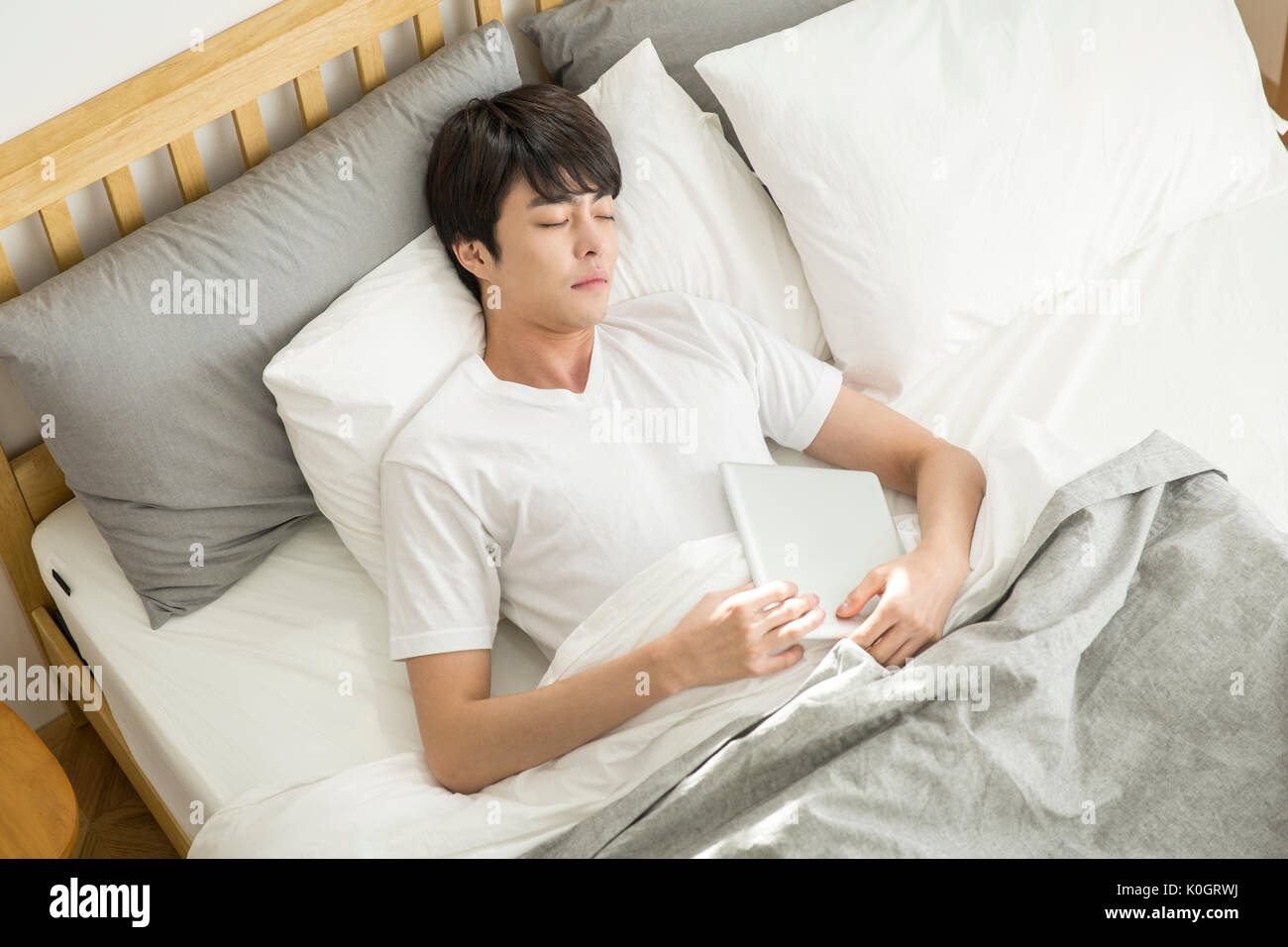 Single man sleeping in bed Stock Photo - Alamy
