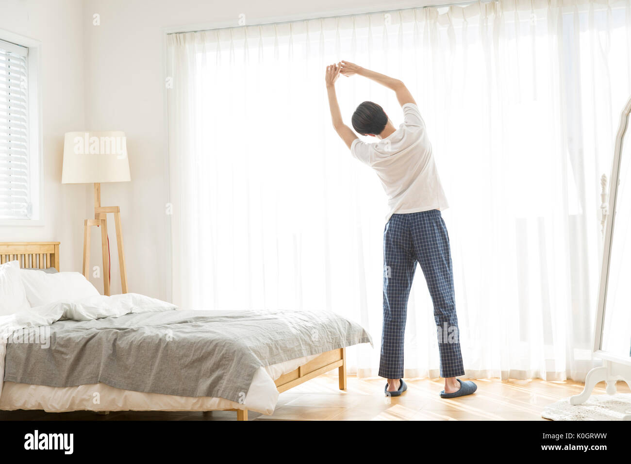 Back of single man standing and stretching his arms Stock Photo - Alamy