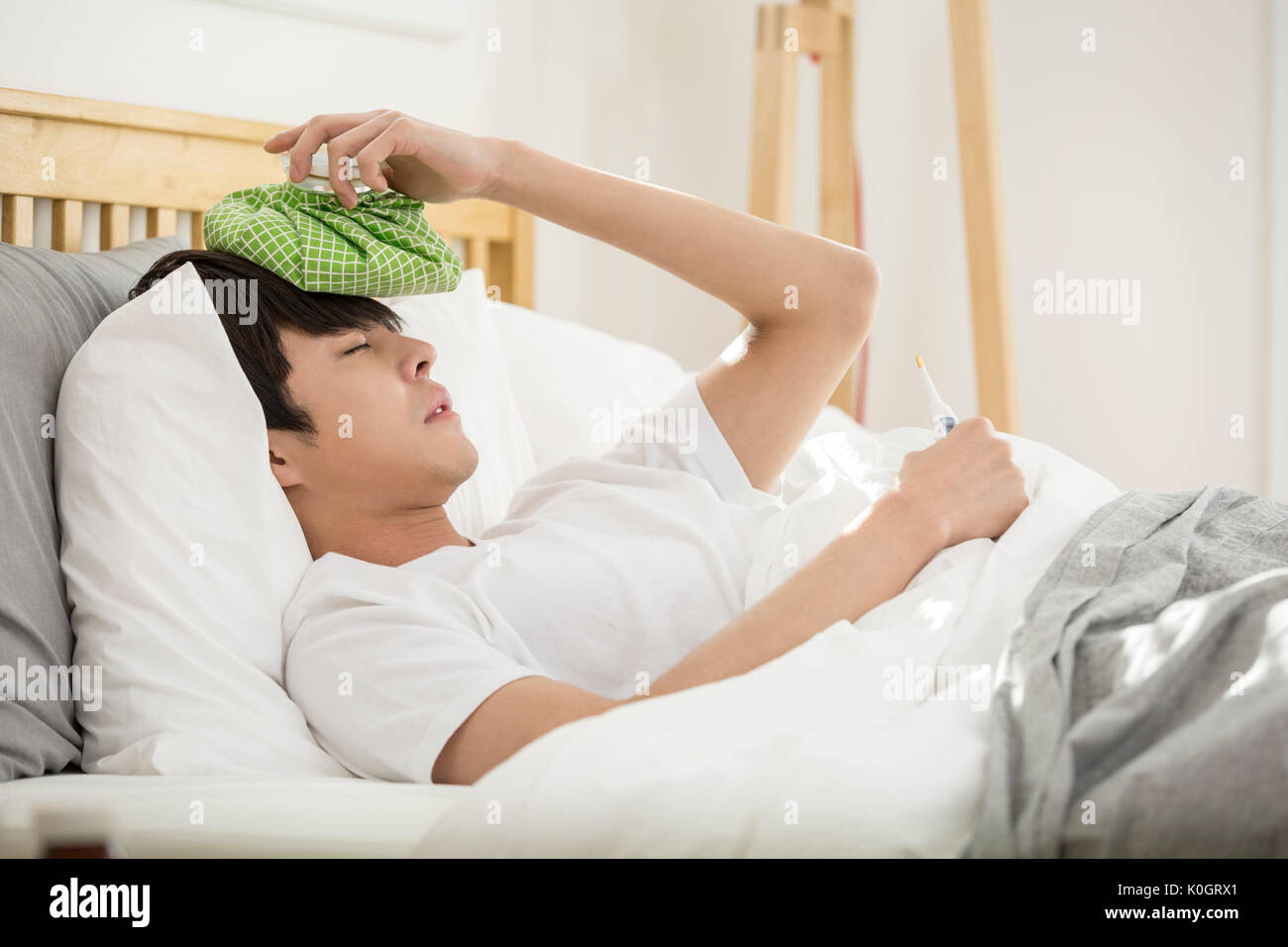 Side view portrait of single man sick lying down in bed Stock Photo - Alamy