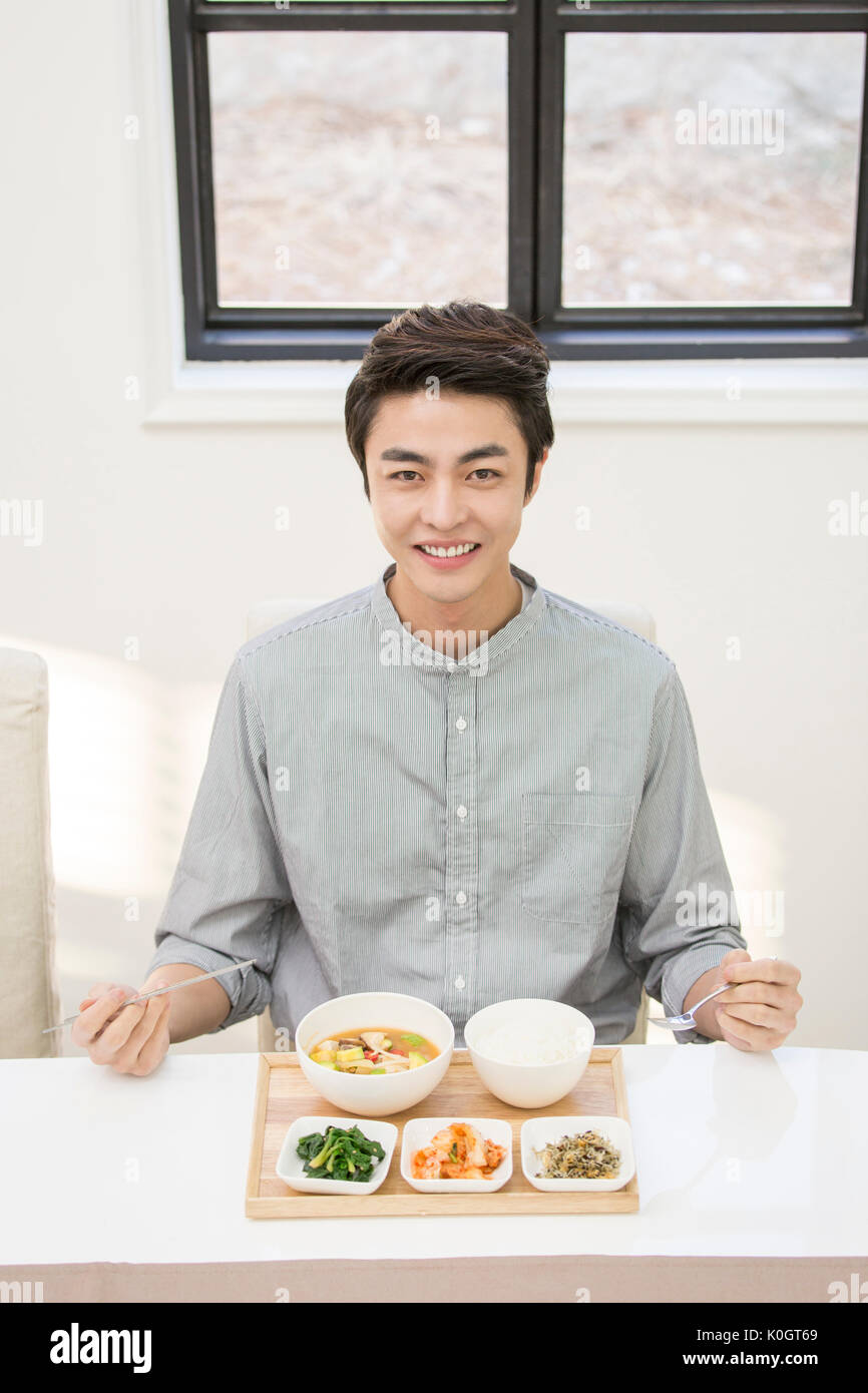 Smi single man having meal alone Stock Photo - Alamy