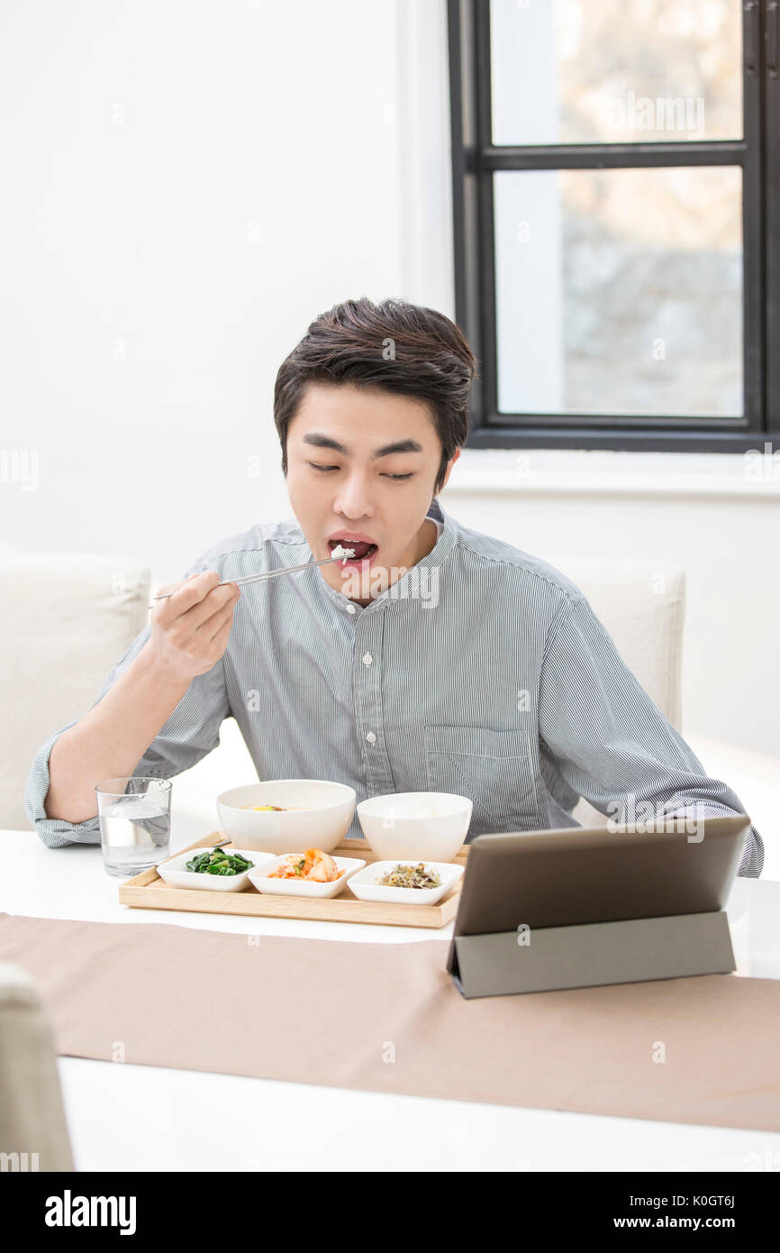 Smiling single man having meal alone Stock Photo - Alamy