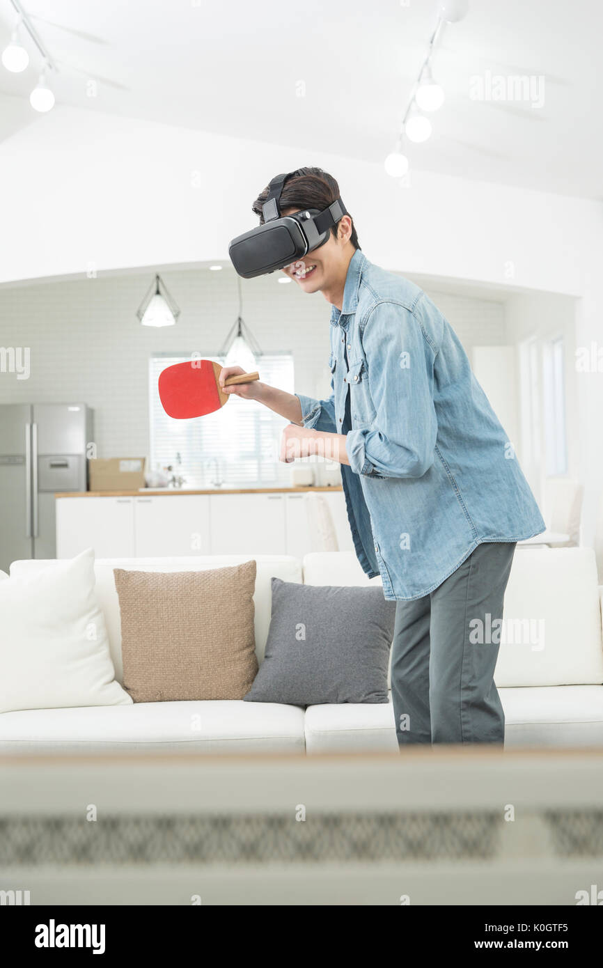 Man enjoying virtual reality table tennis game Stock Photo - Alamy