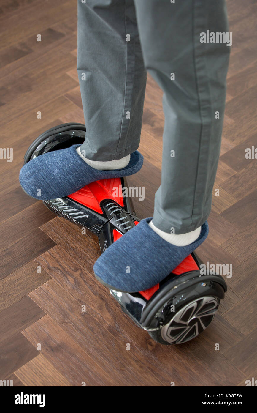 Man standing on a segway scooter Stock Photo - Alamy
