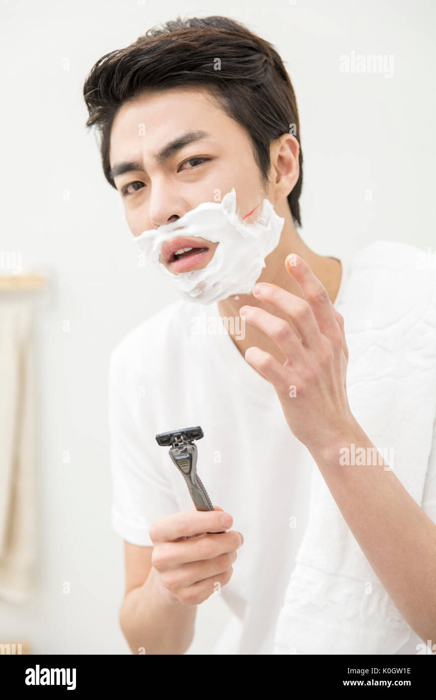 Portrait of grooming shaving and hurting his face Stock Photo - Alamy
