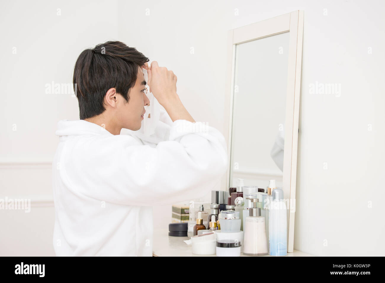 Side view portrait of grooming looking in mirror Stock Photo - Alamy