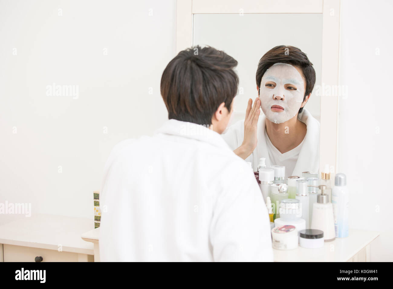 Portrait of grooming putting on beauty mask pack Stock Photo - Alamy