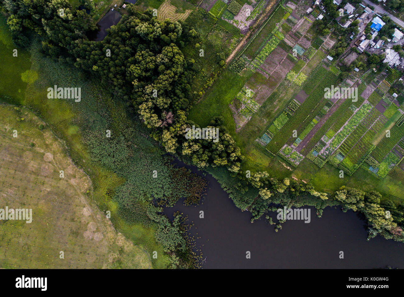 Panoramic view of the valley with green fresh fields and village. Aerial view of countryside ...