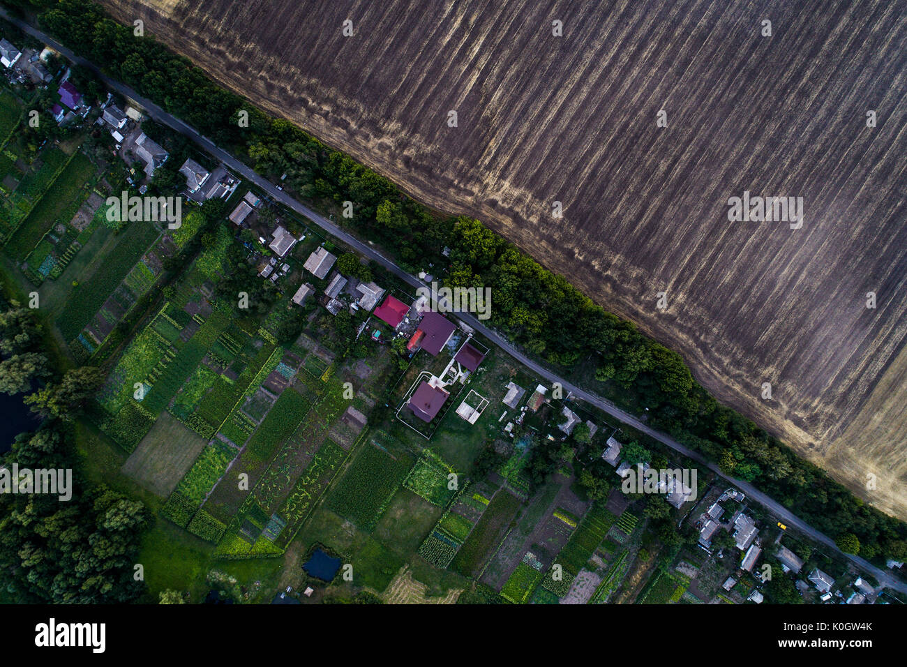 Panoramic view of the valley with green fresh fields and village. Aerial view of countryside ...