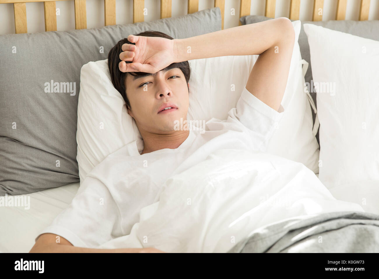 Sick man resting in bed hi-res stock photography and images - Alamy