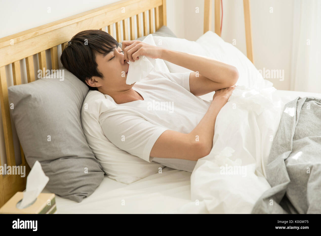 Side view of single man sick resting in bed Stock Photo - Alamy