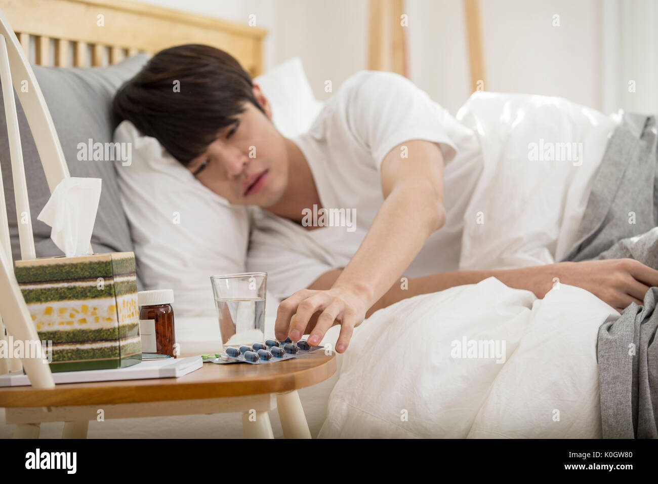 Sick person taking pills hi-res stock photography and images - Alamy