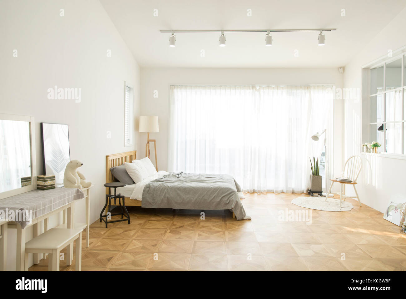 Interior with dressing table, windows and bed Stock Photo - Alamy