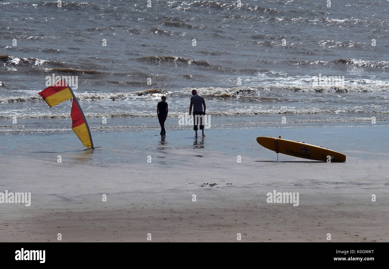 Safety flags and life guards fron RNLI on east coast beach at low tide ...