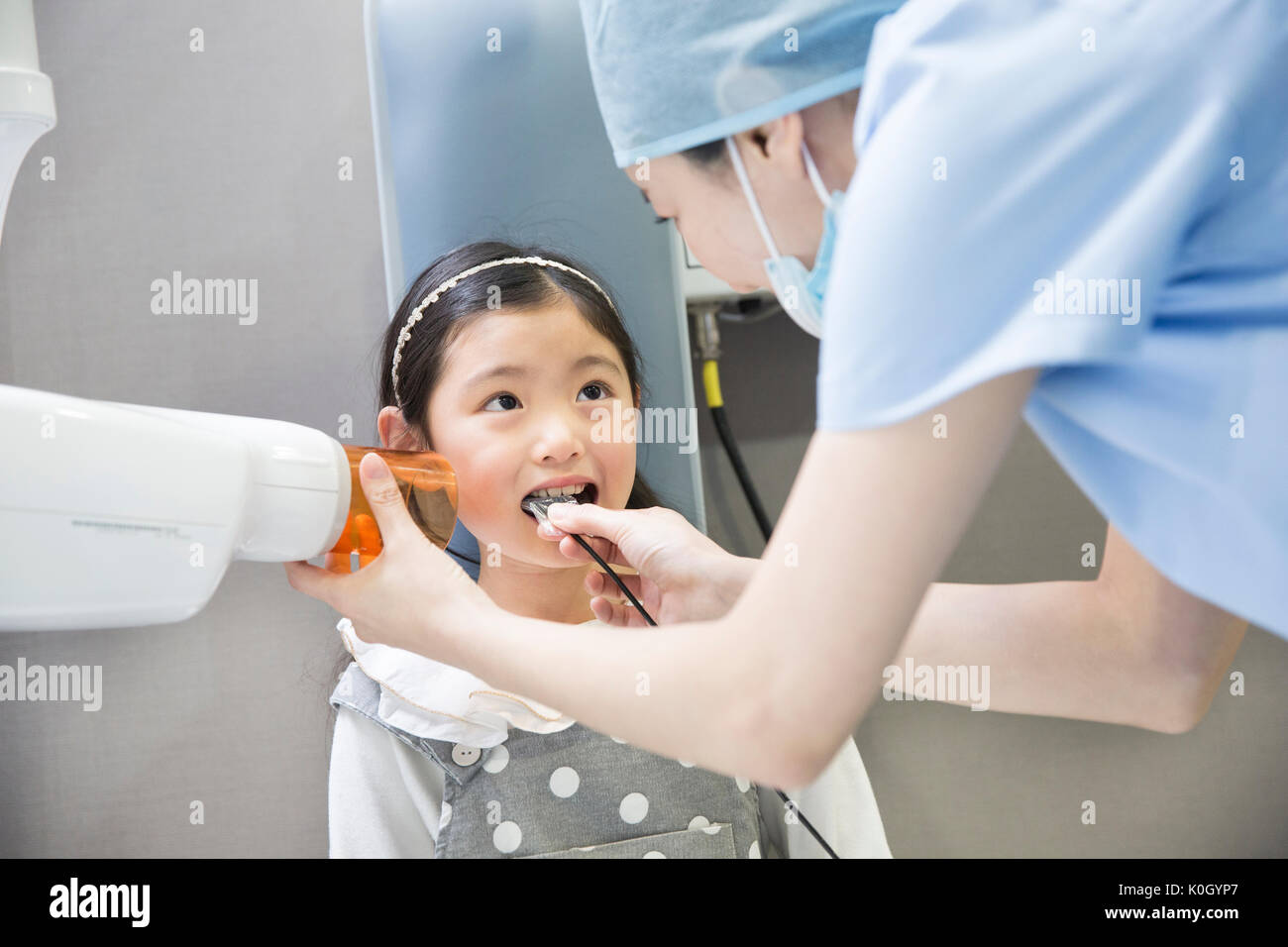 Portrait of girl patient getting treatment at dental clinic Stock Photo ...