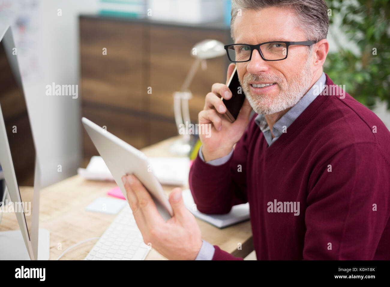 Busy man in the surrounding of technology Stock Photo - Alamy