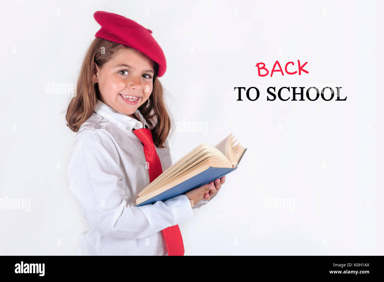 Happy girl with a book, back to school Stock Photo - Alamy