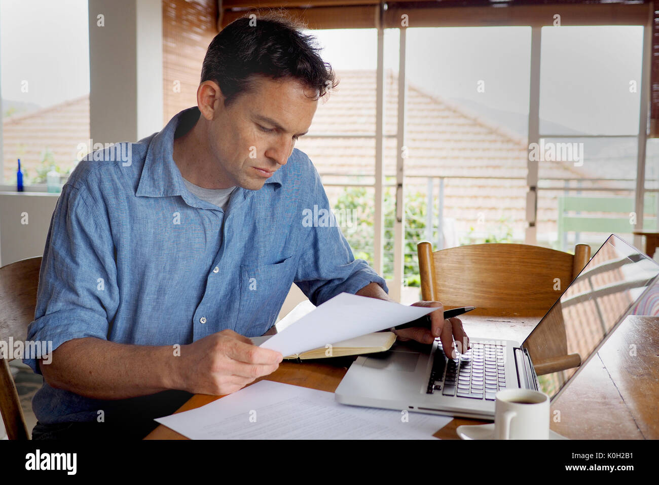 Man in home office using computer Stock Photo - Alamy