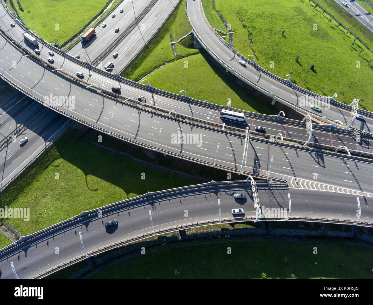 Multi-level interchange of city ringroad with driving vehicles. Aerial ...