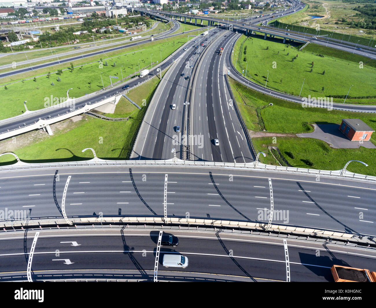 Crossing the roads at a multilevel interchange, aerial view. Green ...