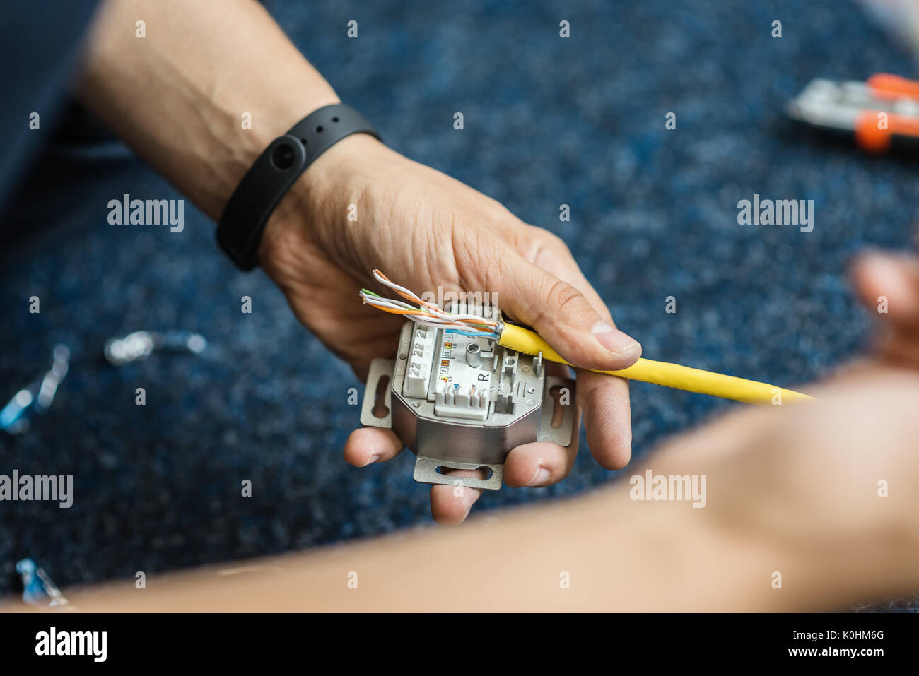 Specialist connect a network cable with RJ45 sockets, process of laying ...