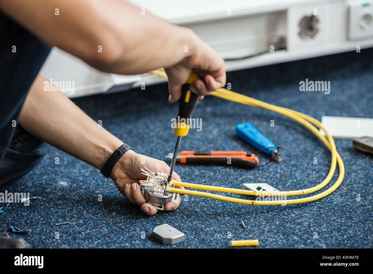 Specialist connect a network cable with RJ45 sockets, process of laying ...