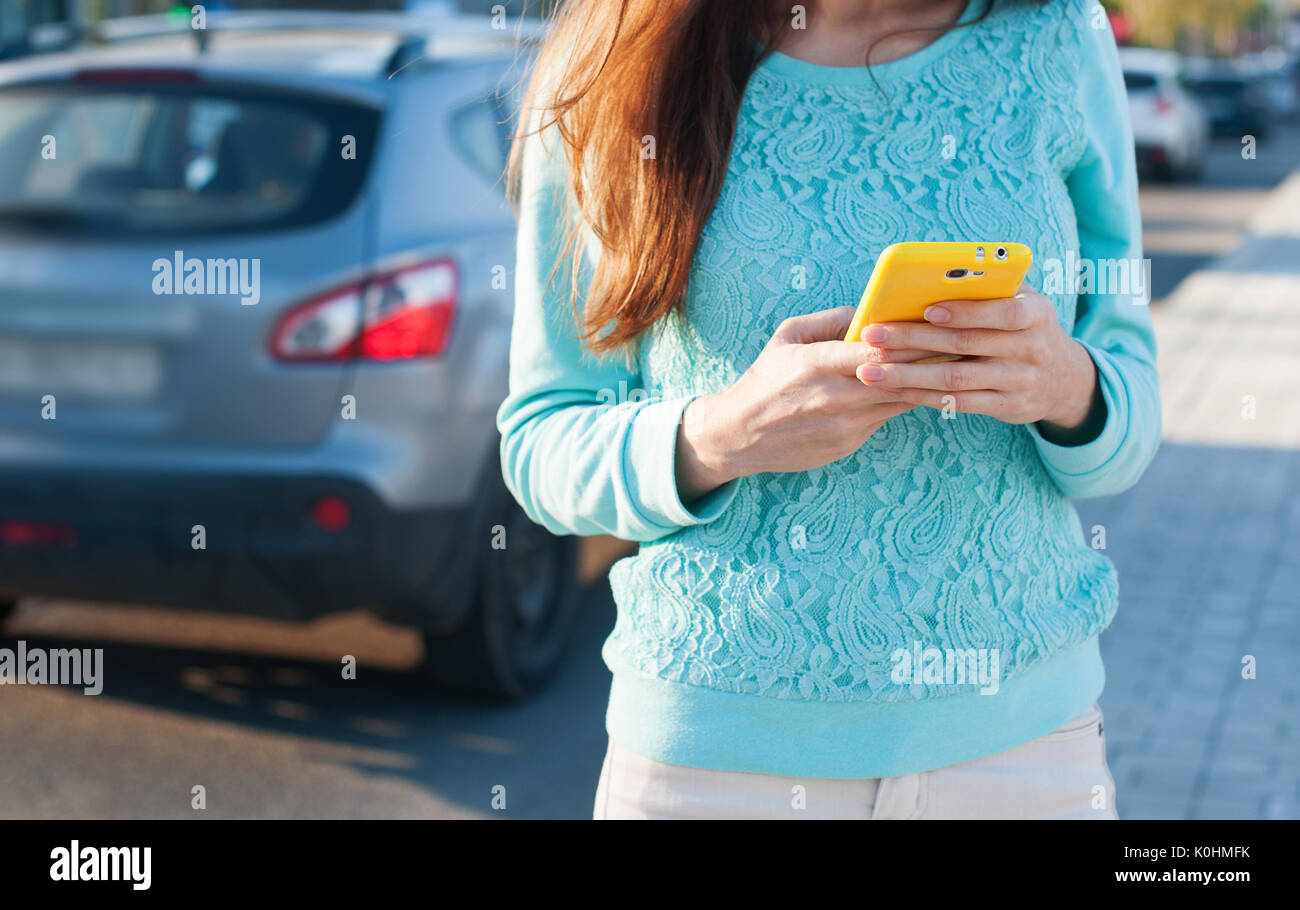 Woman with phone dialing message Stock Photo - Alamy