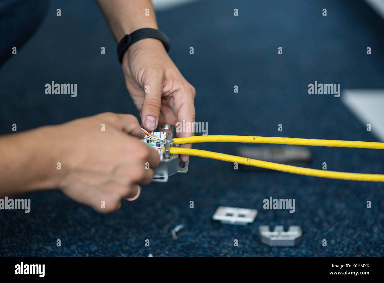 Specialist connect a network cable with RJ45 sockets, process of laying ...