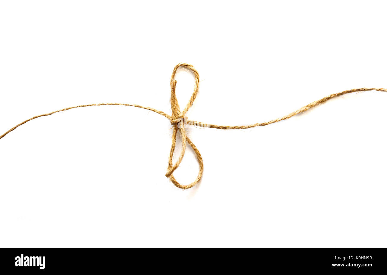 Flax rope with bow on white background Stock Photo - Alamy