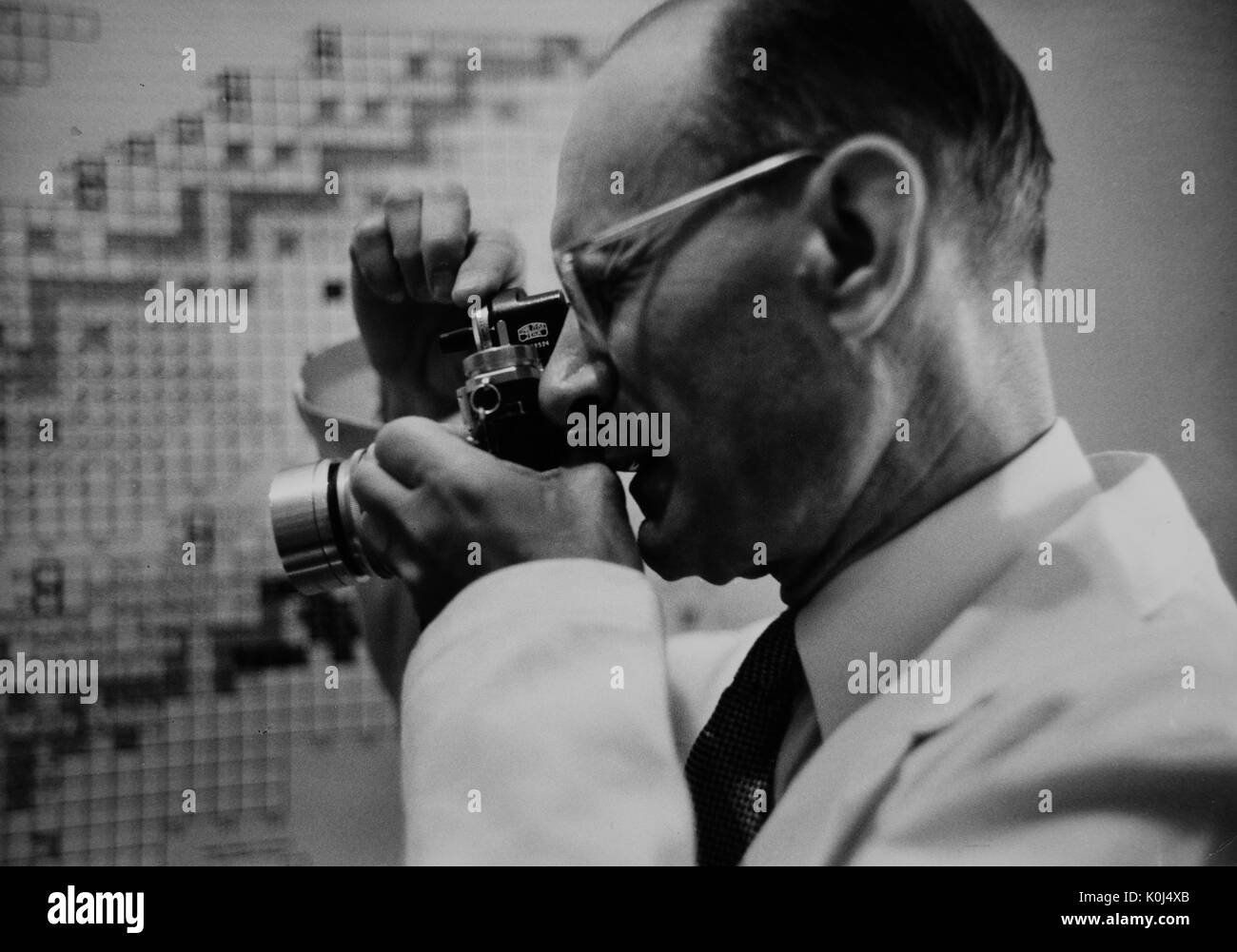 Candid photograph of Italian scientist Franco Rasetti taking a picture ...