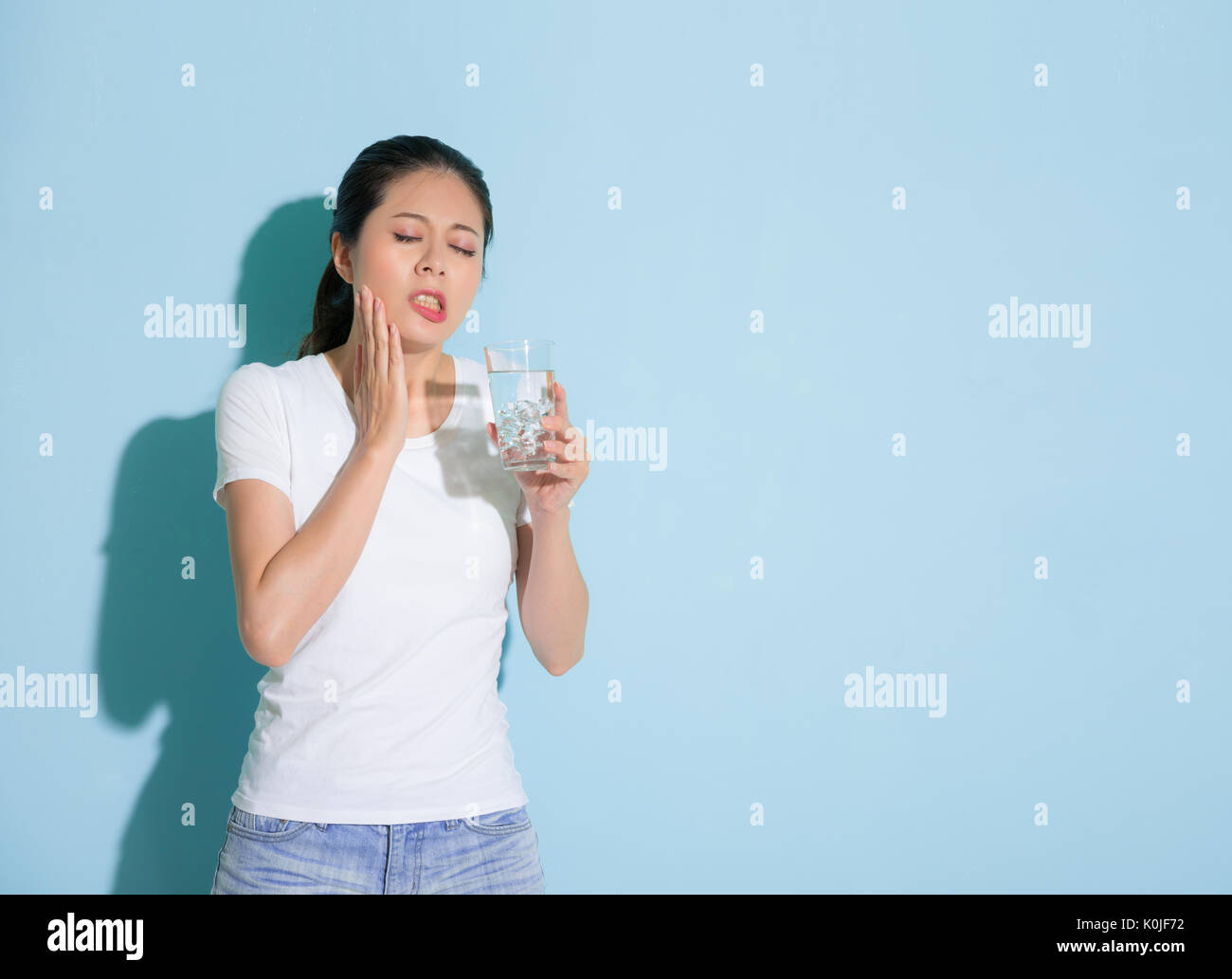 sweet lovely woman after drinking ice water feeling sensitive tooth ...