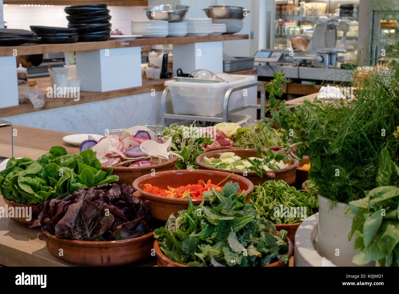 fresh vegetables in restaurant kitchen, chopped and ready for food ...