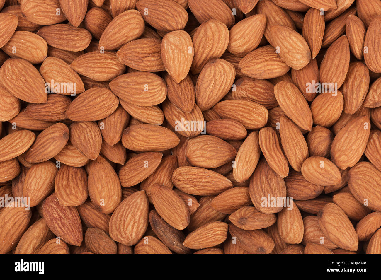 Pile of almonds close-up as background. food texture Stock Photo - Alamy