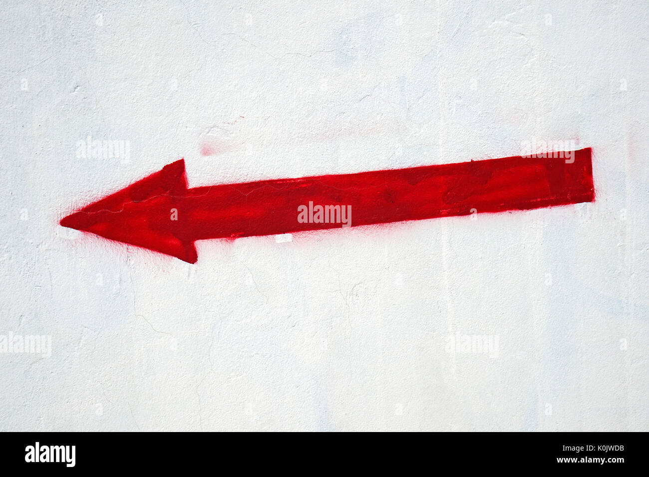 Red arrow sign on the wall Stock Photo - Alamy
