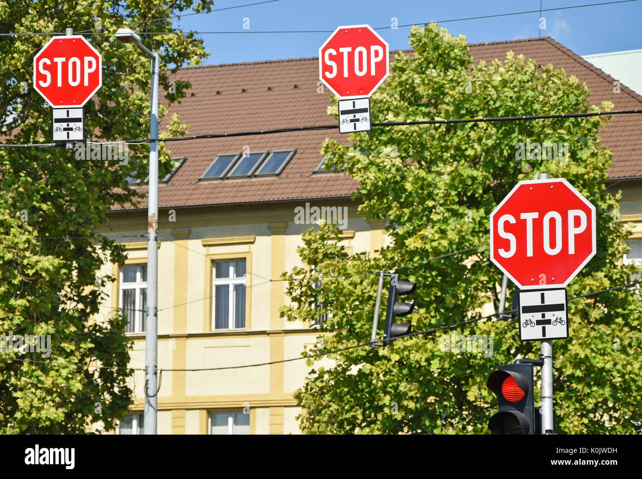 Stop signs at the road crossing Stock Photo - Alamy