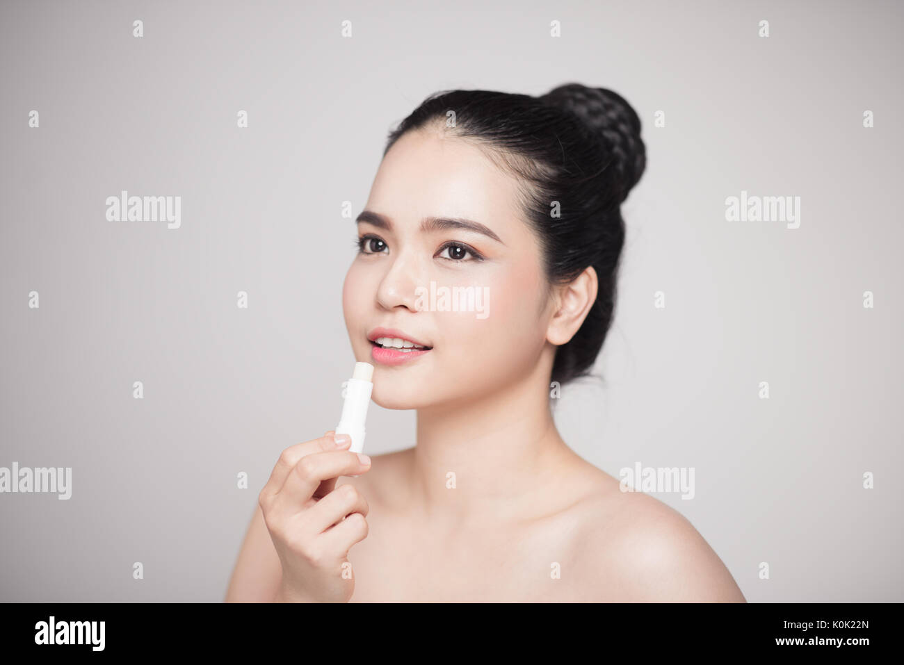 Asian model applying lips hi-res stock photography and images - Alamy